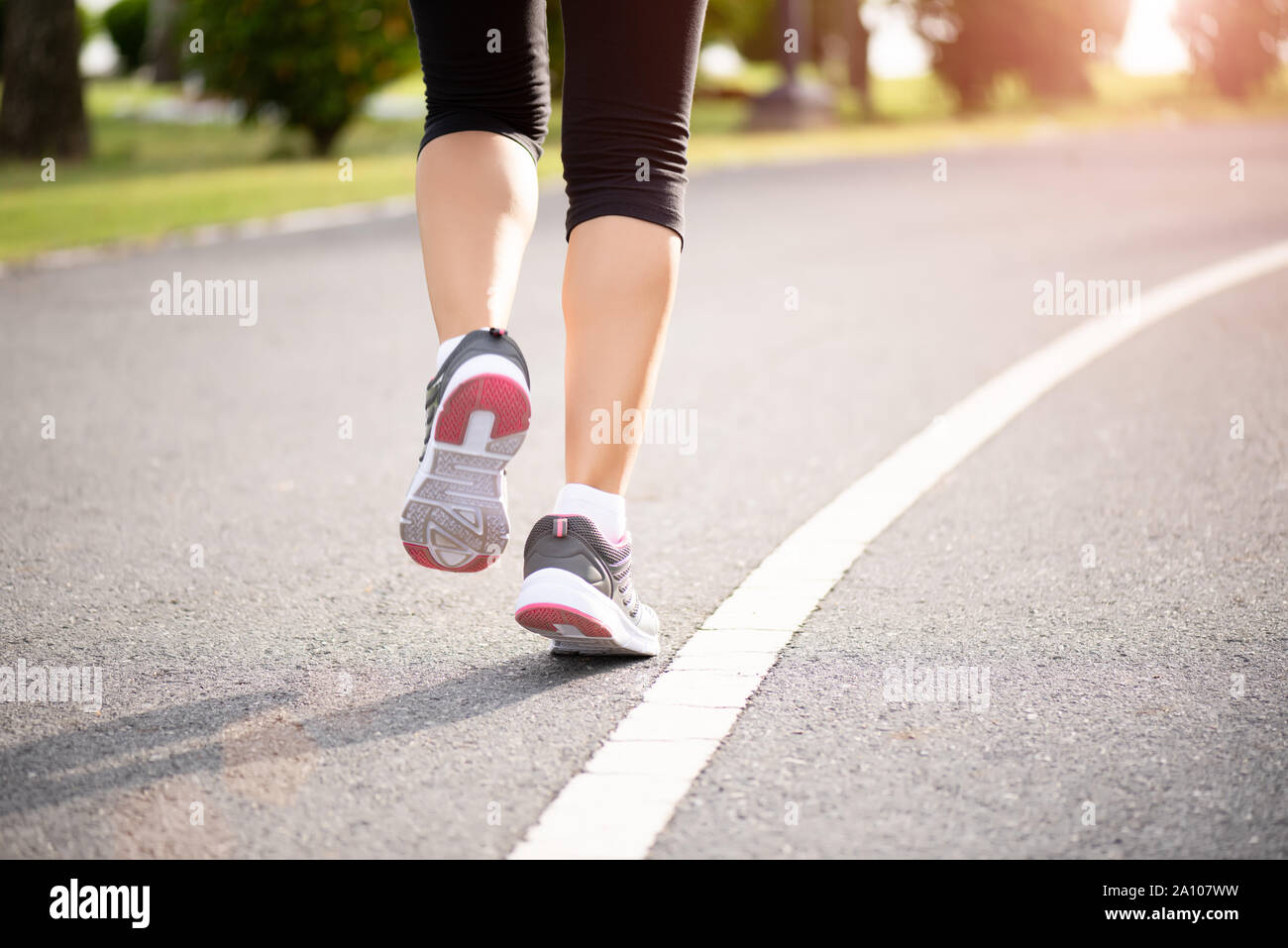 Closeup woman running towards on the road side. Step, run and outdoor ...
