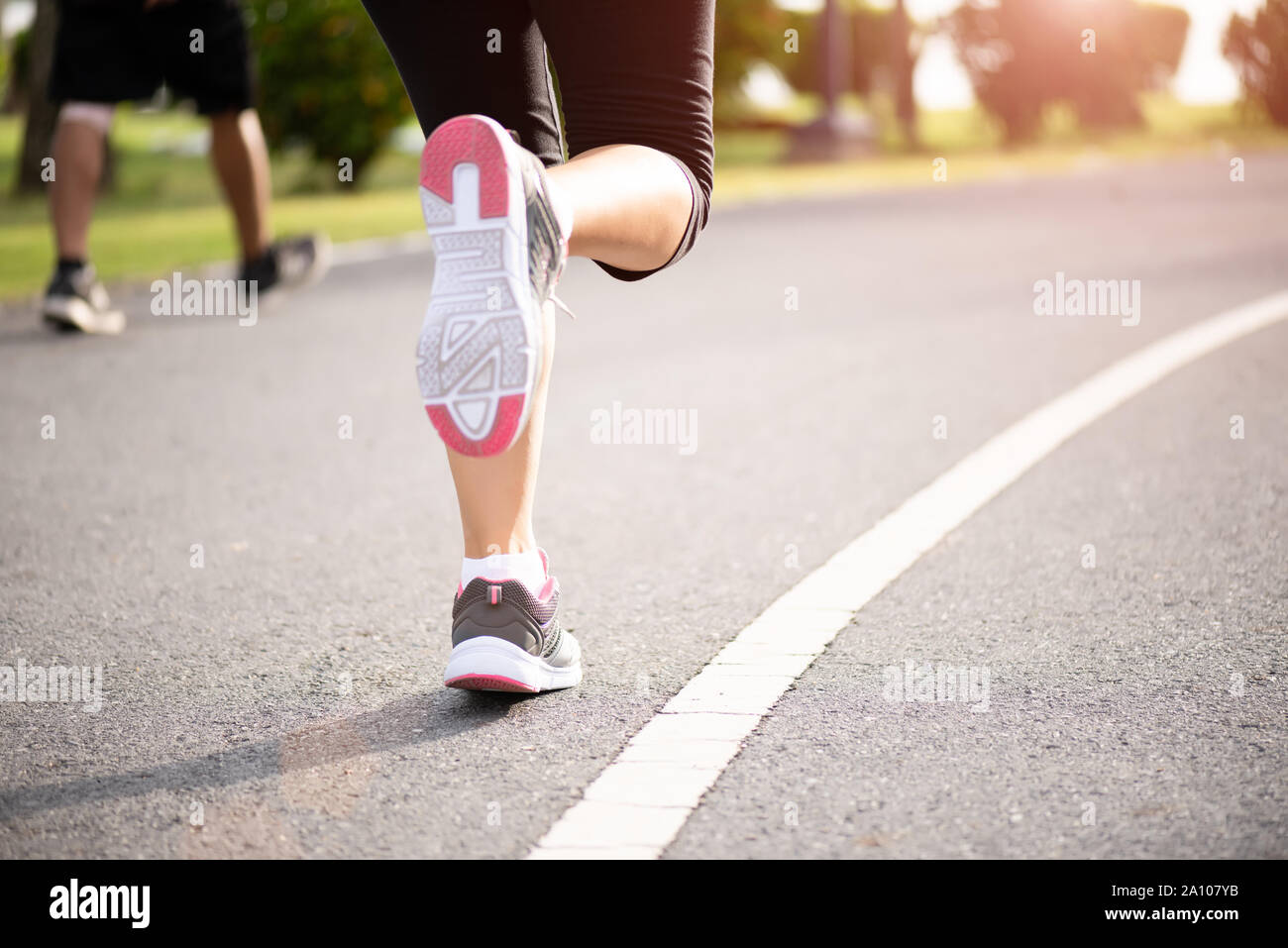 Closeup woman running towards on the road side. Step, run and outdoor ...