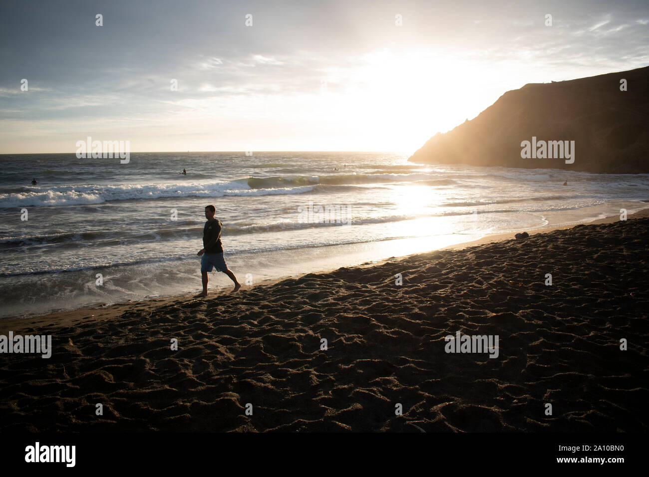 A man walks along Rodeo Beach in the Marin Headlands Stock Photo - Alamy