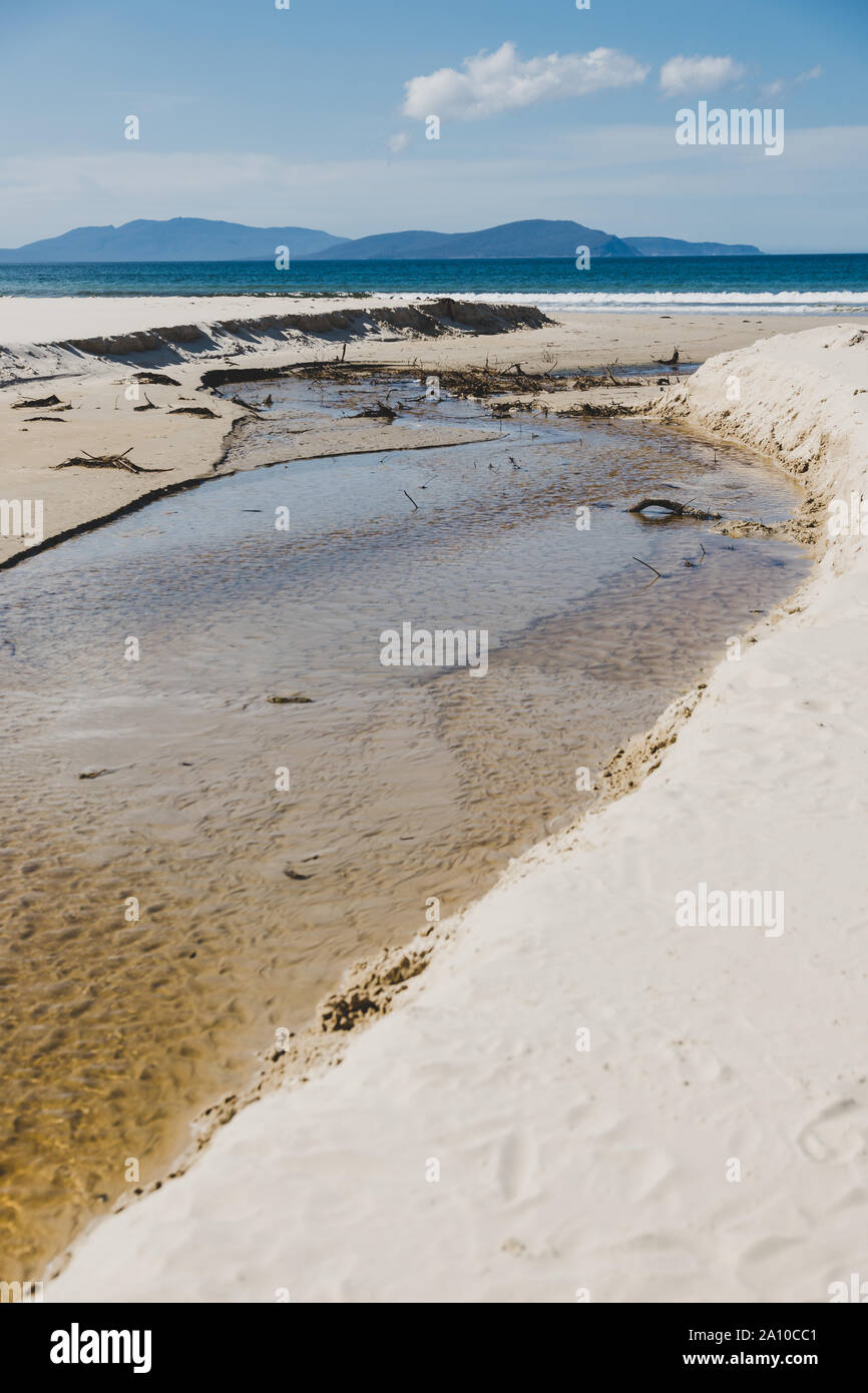 river estuary across the beach meeting the South Pacific Ocean in ...
