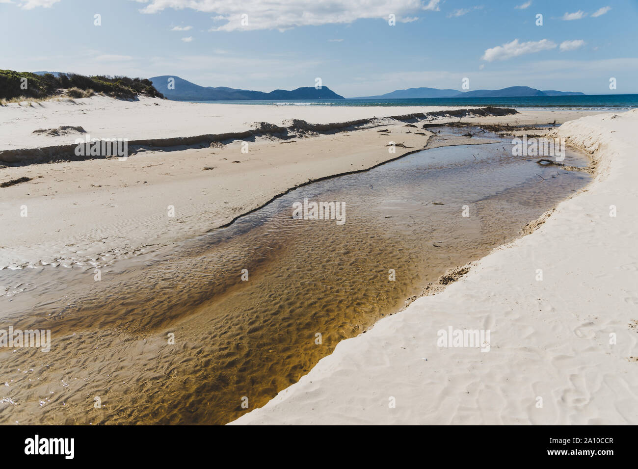 river estuary across the beach meeting the South Pacific Ocean in ...