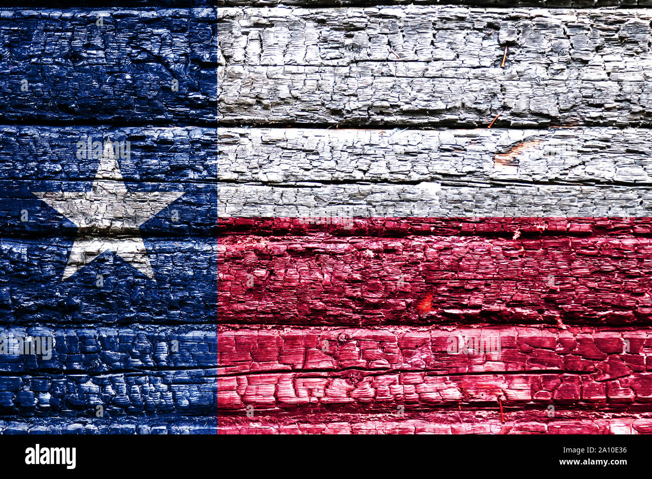The national flag of the US state Texas in against a black charred ...