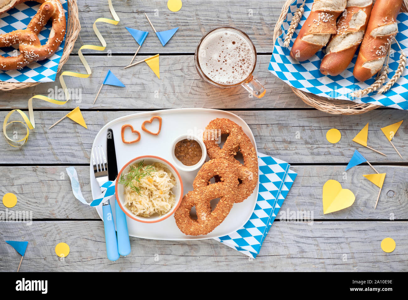 Oktoberfest traditional food and beer. Leberwurst pretzels with ...