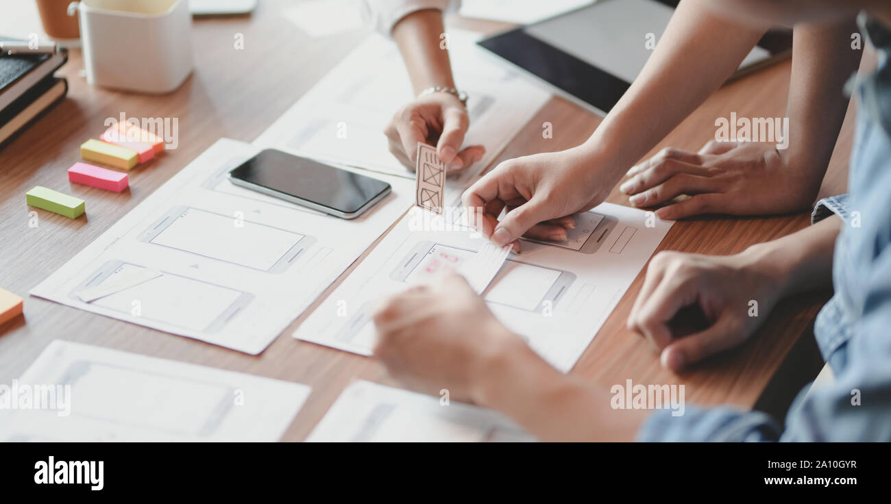 Group of young professional UI graphic designer discussing on their ...