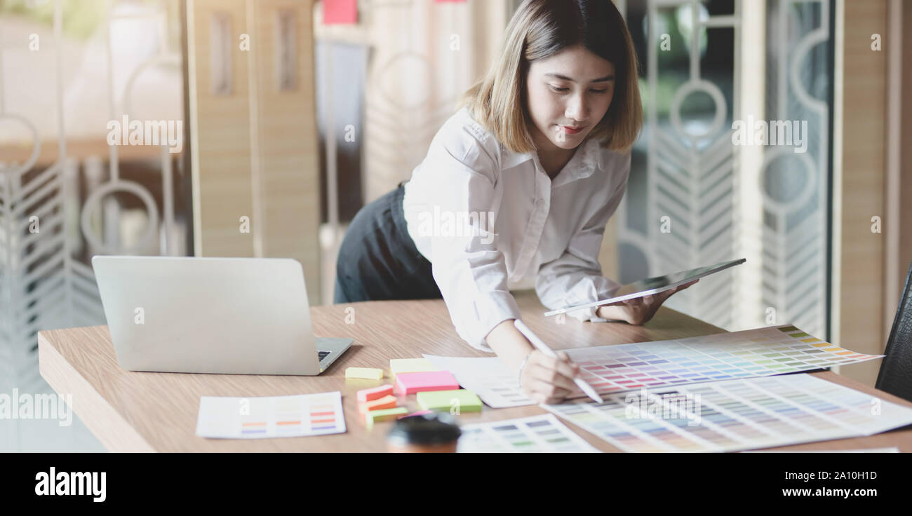Young female professional UI graphic designer choosing colours for ...