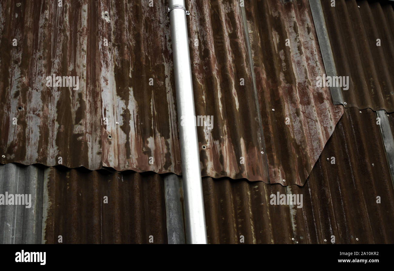 Spoiled and dirty metallic background, detail of a steel door down and ...