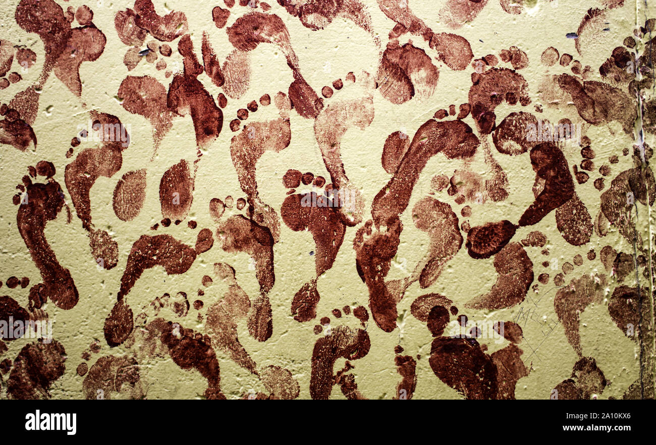 Footprints painted on wall, symbol and texture Stock Photo - Alamy