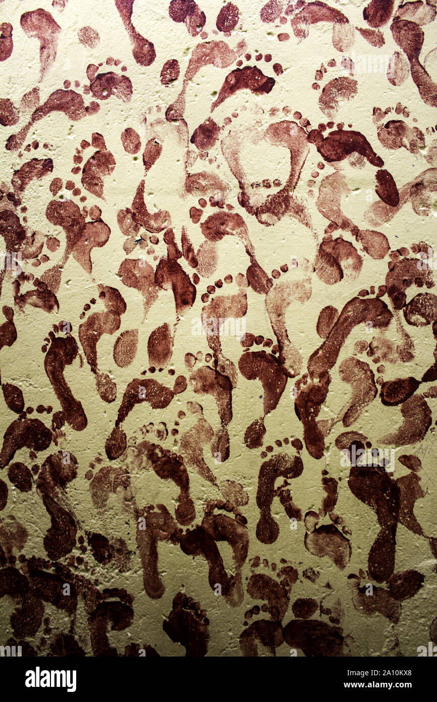 Footprints painted on wall, symbol and texture Stock Photo - Alamy