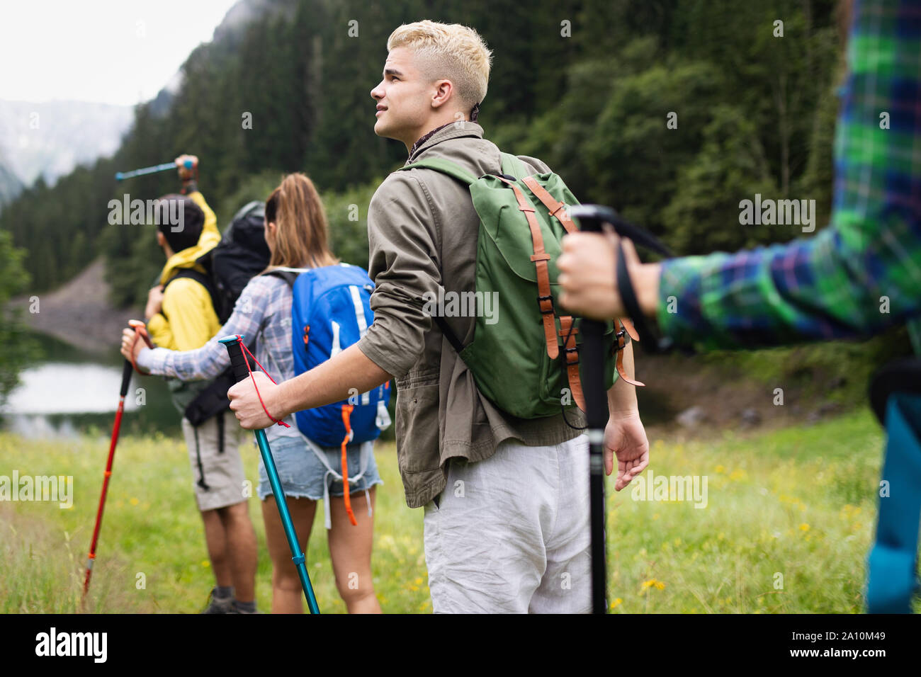 Hiking with friends is so fun. Group of young people with backpacks ...