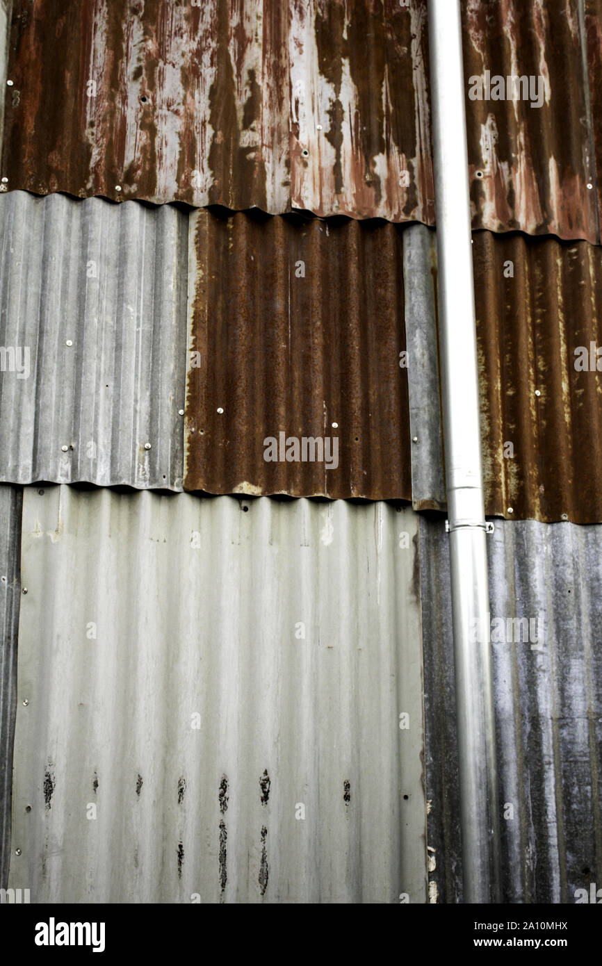 Spoiled and dirty metallic background, detail of a steel door down and ...