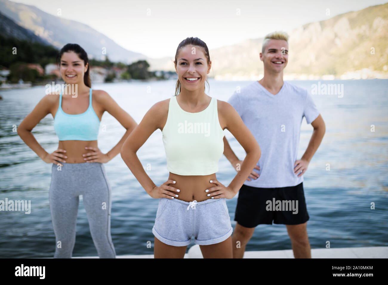 Group of happy friends or sportsmen exercising and stretching outdoor ...