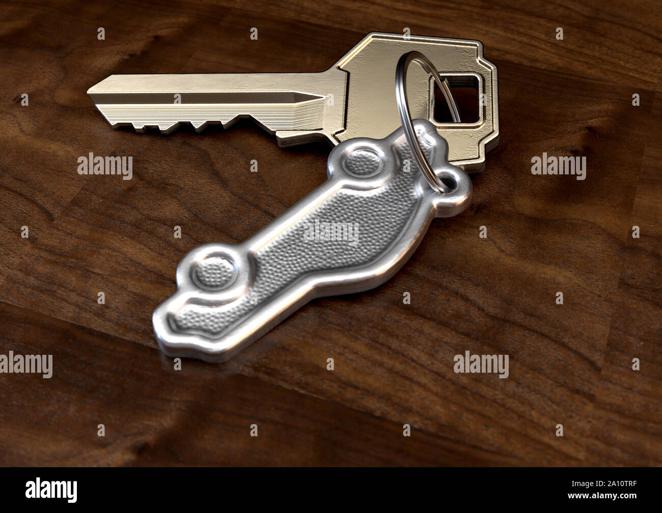 A brass key attached to a cast iron keyring in the shape of a car on an ...