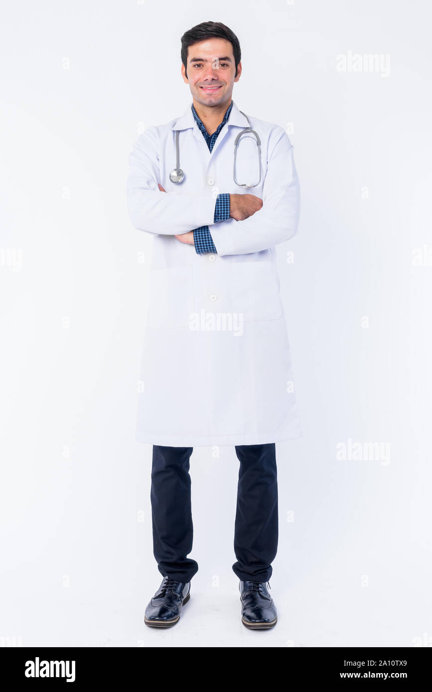 Full body shot of happy young Persian man doctor smiling with arms ...