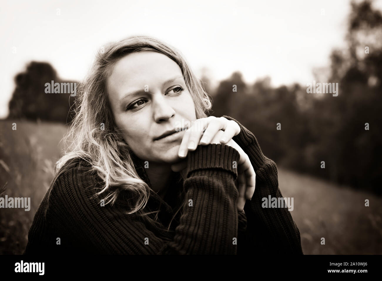 Girl pondering over something Stock Photo - Alamy