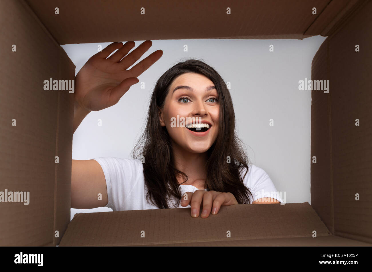 Excited Girl Looking Inside Empty Box, Bottom View Stock Photo - Alamy
