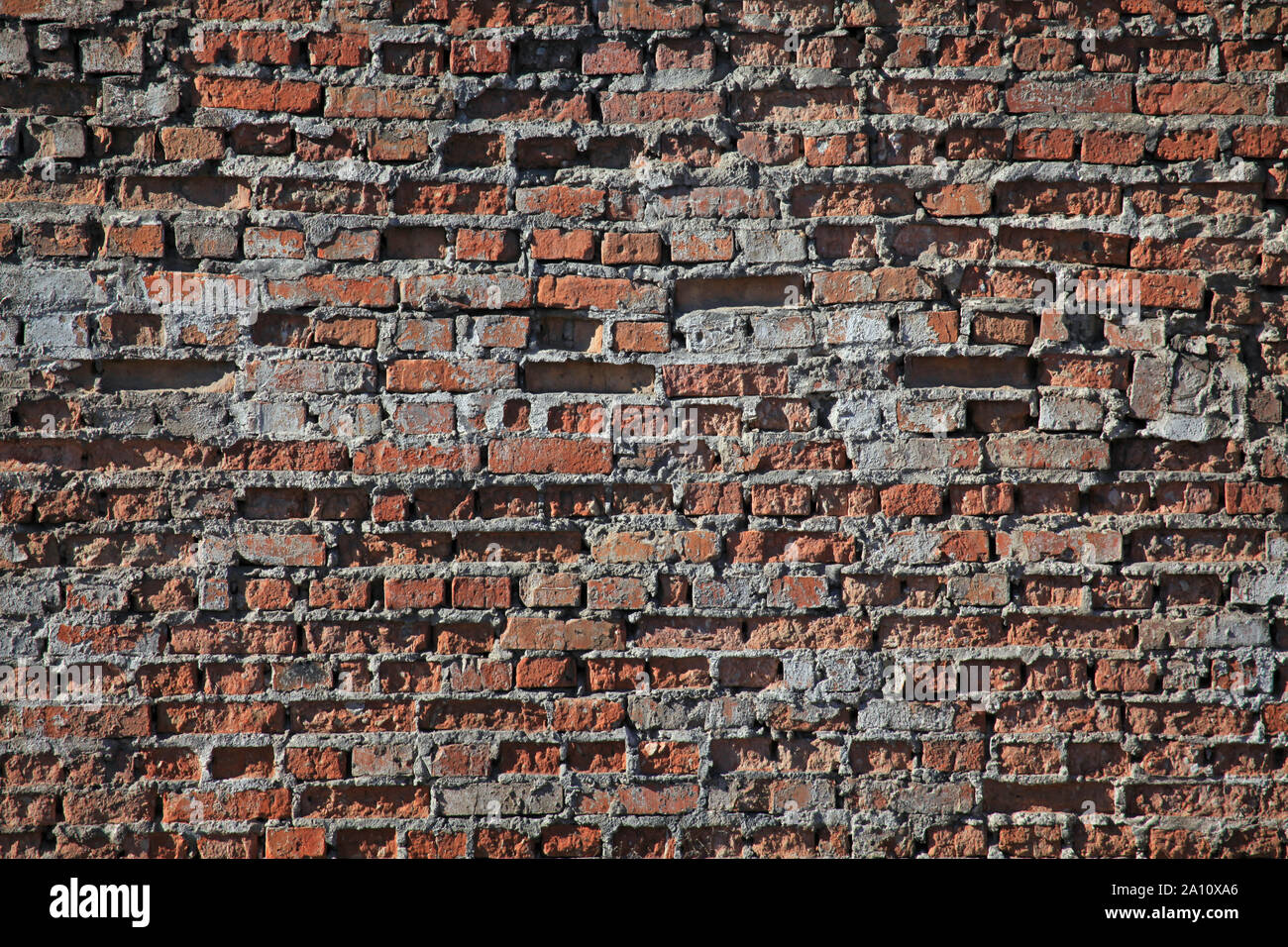 Old brick wall texture. The wall, made of old red bricks, darkened by ...