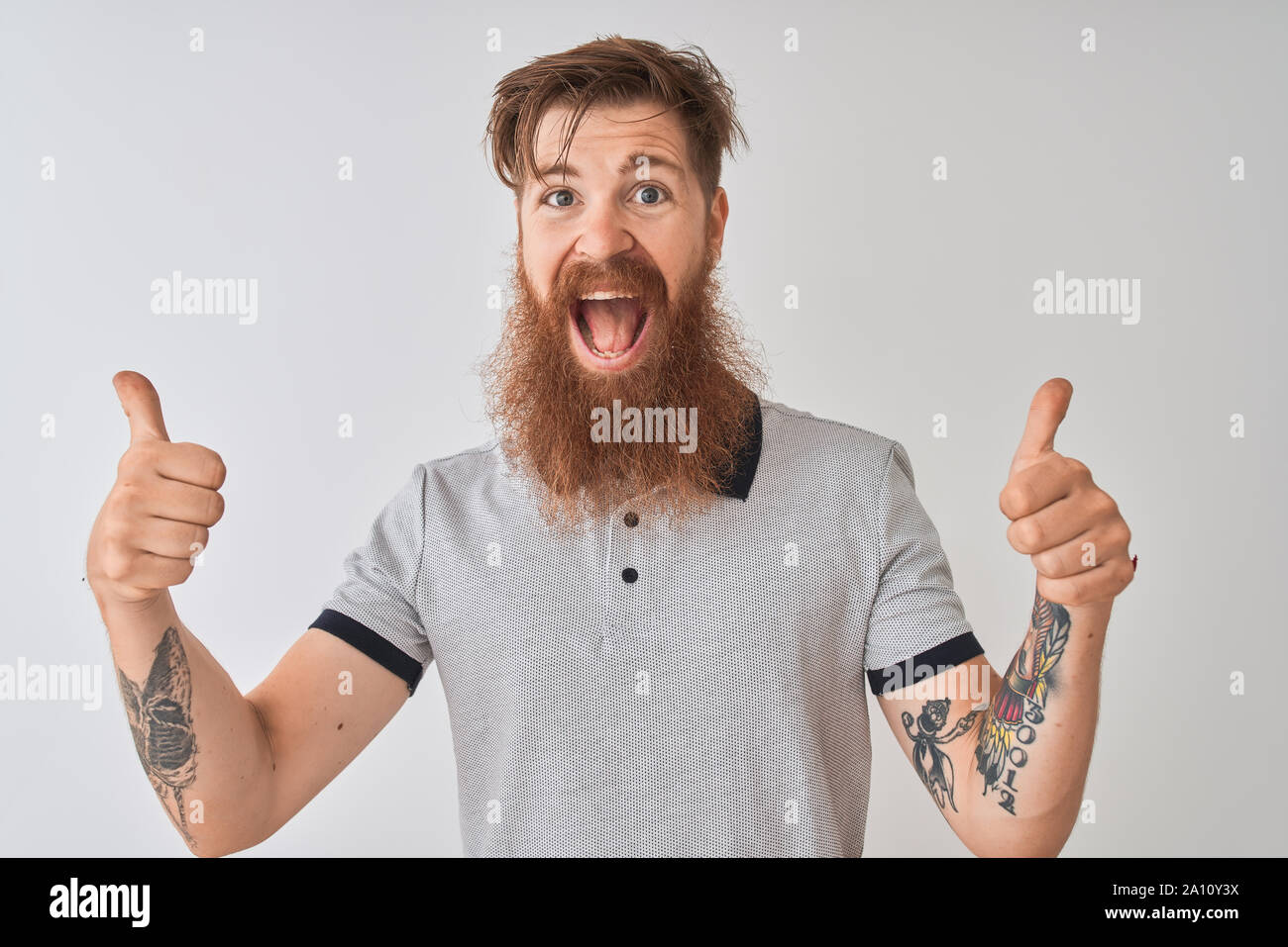 Young redhead irish man wearing grey polo standing over isolated white ...