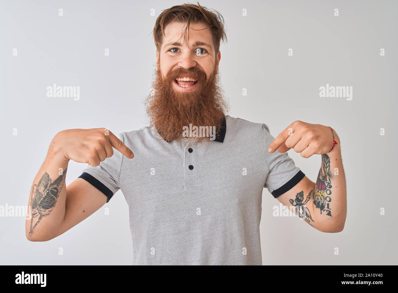 Young redhead irish man wearing grey polo standing over isolated white ...