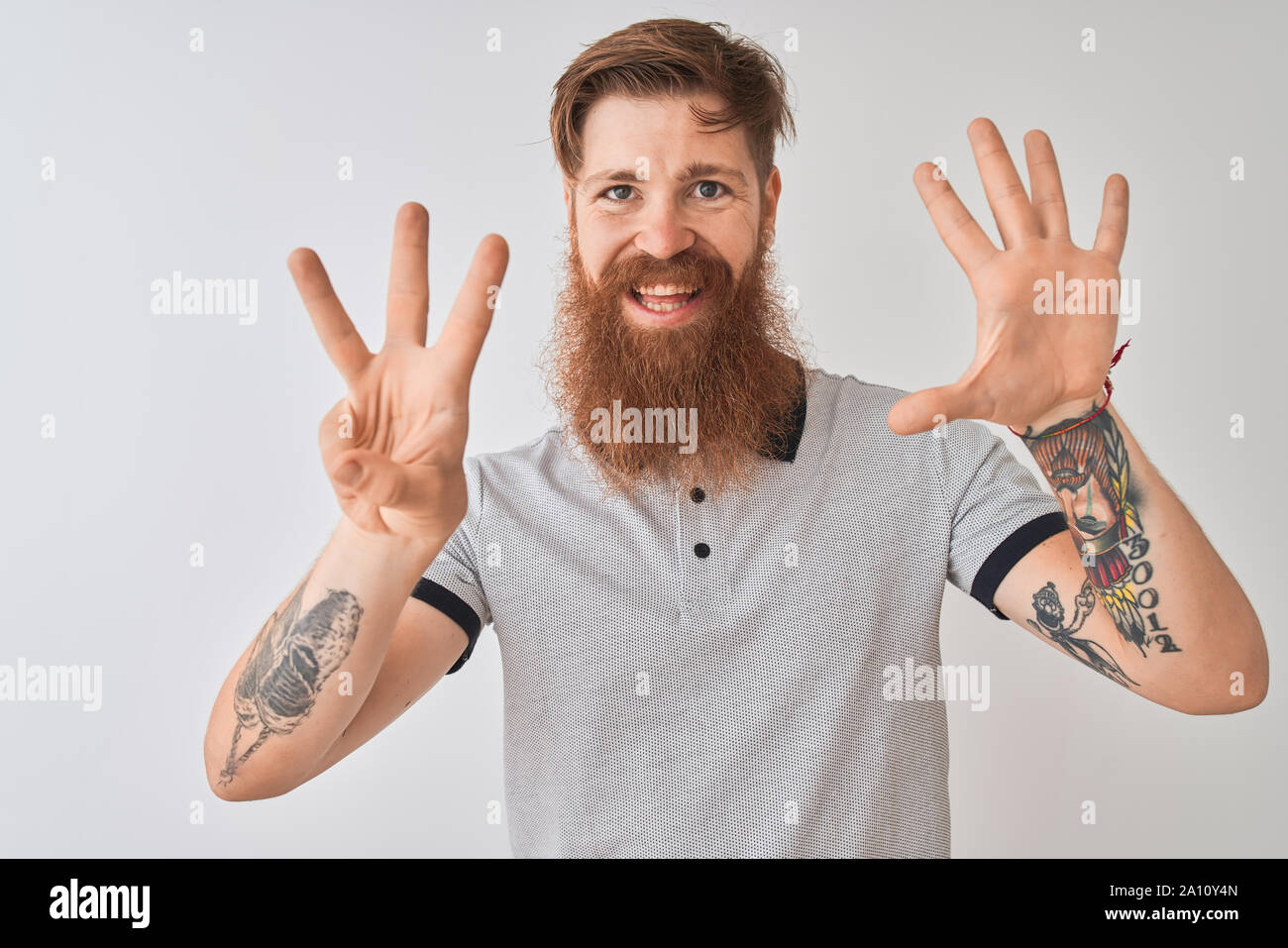 Young redhead irish man wearing grey polo standing over isolated white ...