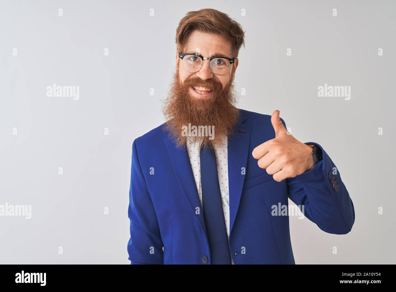 Young redhead irish businessman wearing suit and glasses over isolated ...