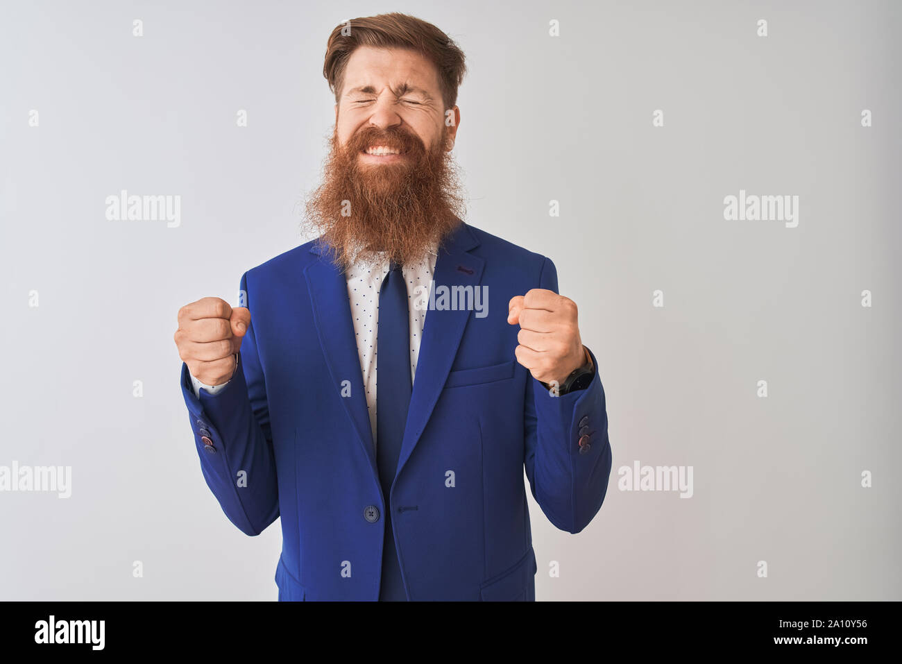 Young redhead irish businessman wearing suit standing over isolated ...