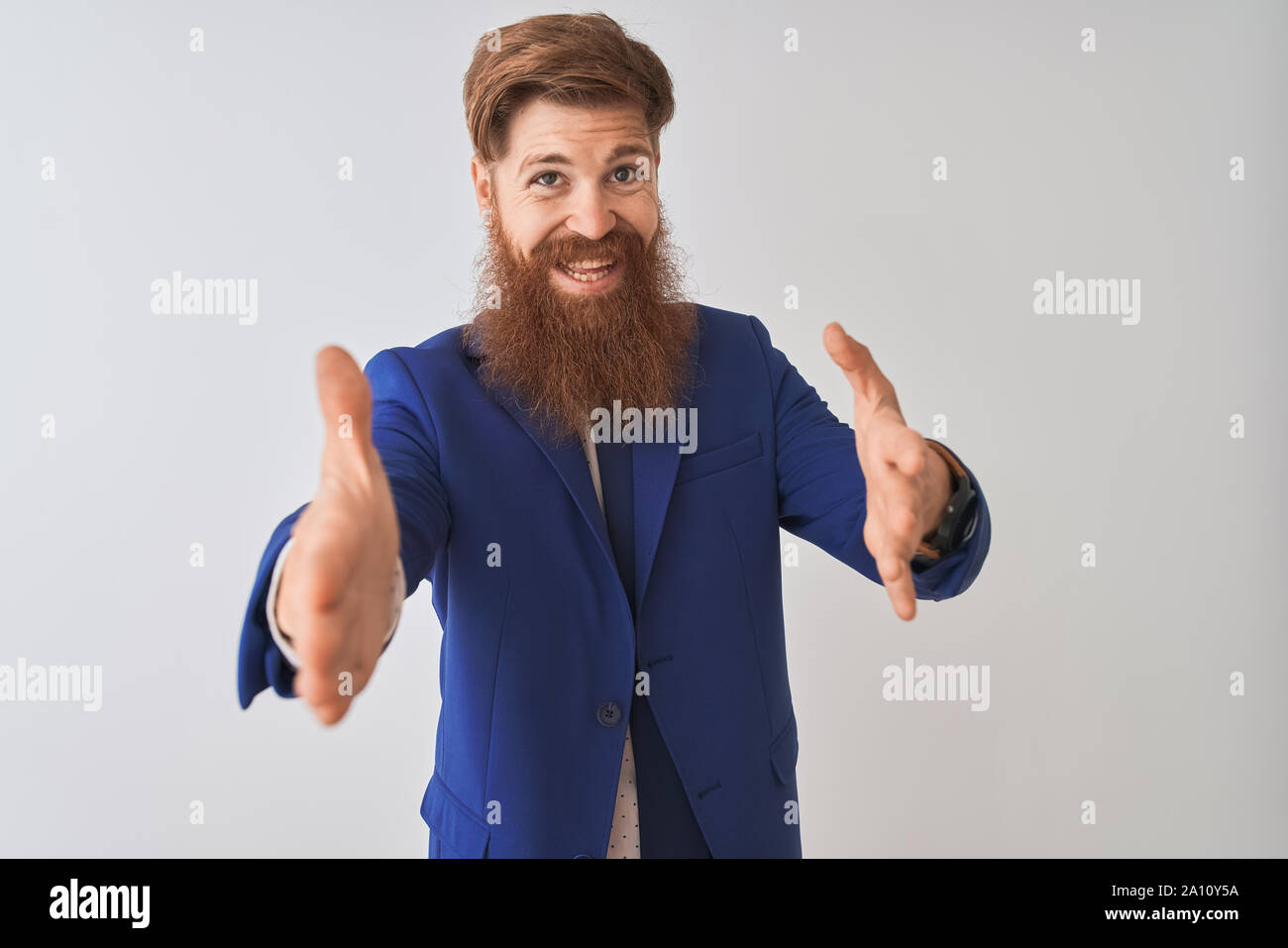Young redhead irish businessman wearing suit standing over isolated ...