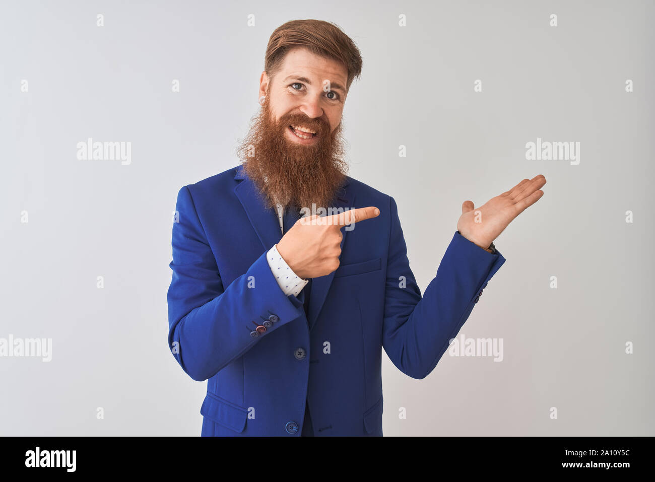 Young redhead irish businessman wearing suit standing over isolated ...