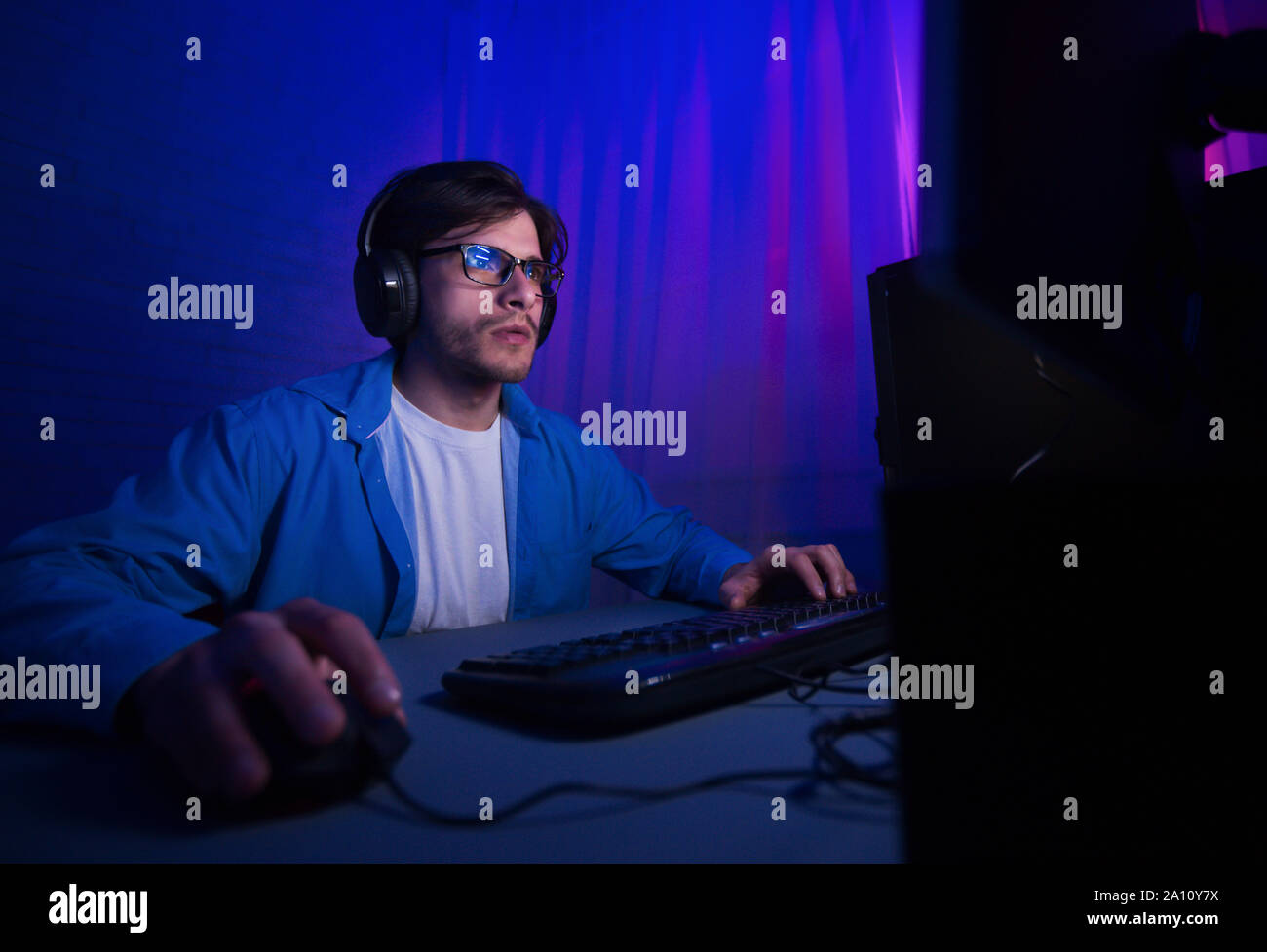 Professional gamer playing in first-person shooter video game Stock ...