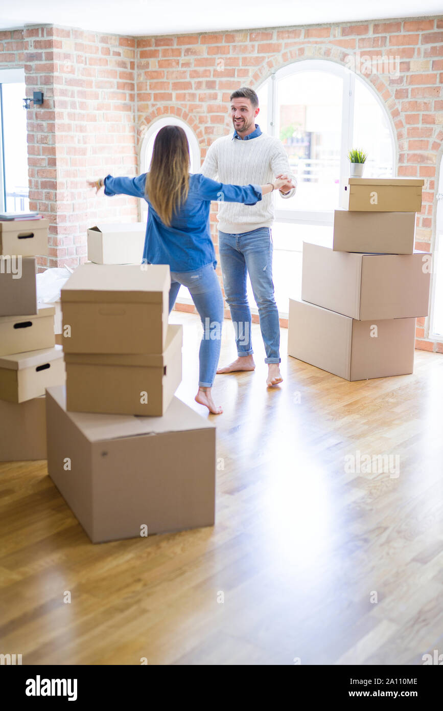 Young beautiful couple dancing at new home around cardboard boxes Stock ...