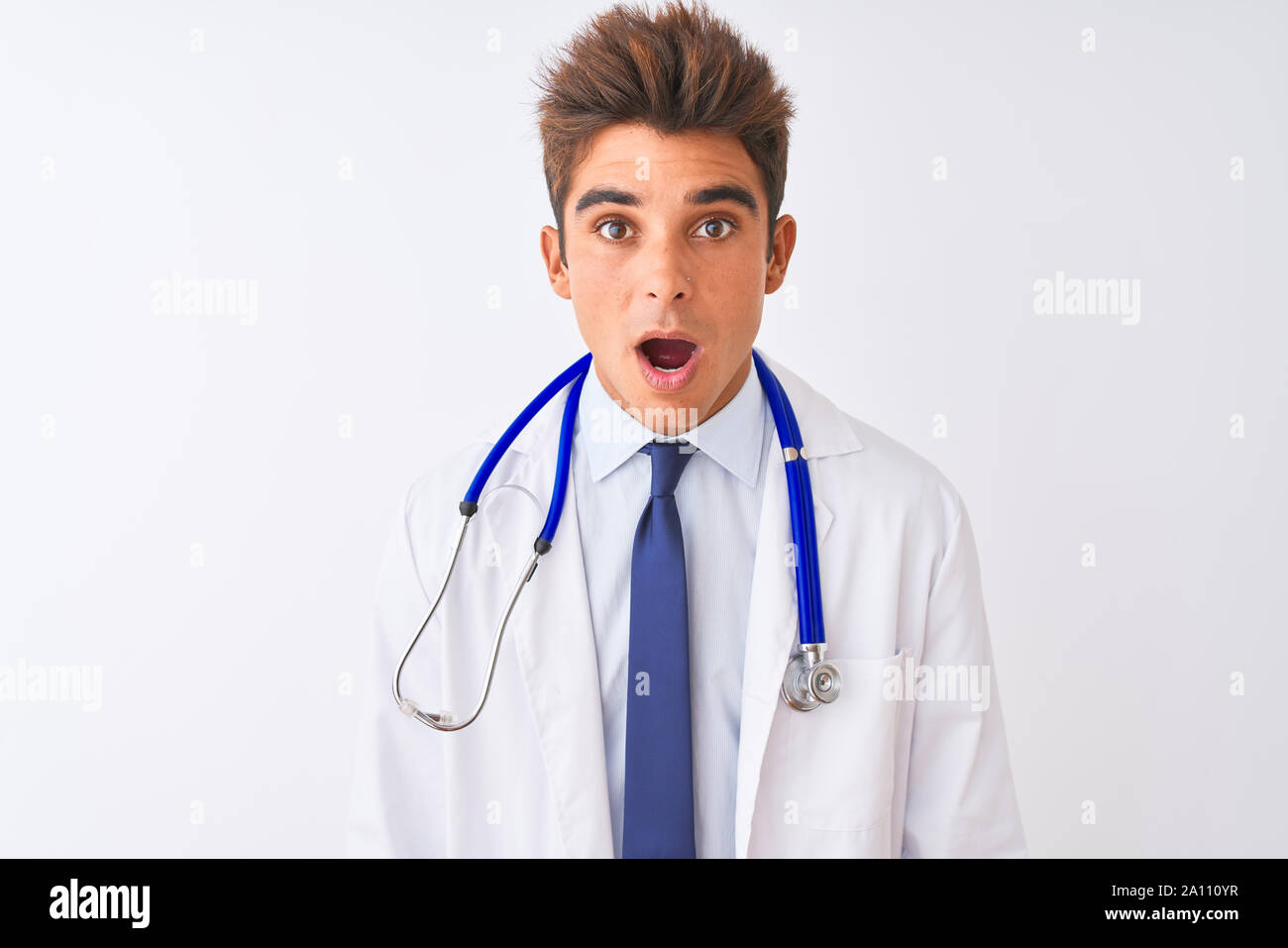 Young handsome doctor man wearing stethoscope over isolated white ...