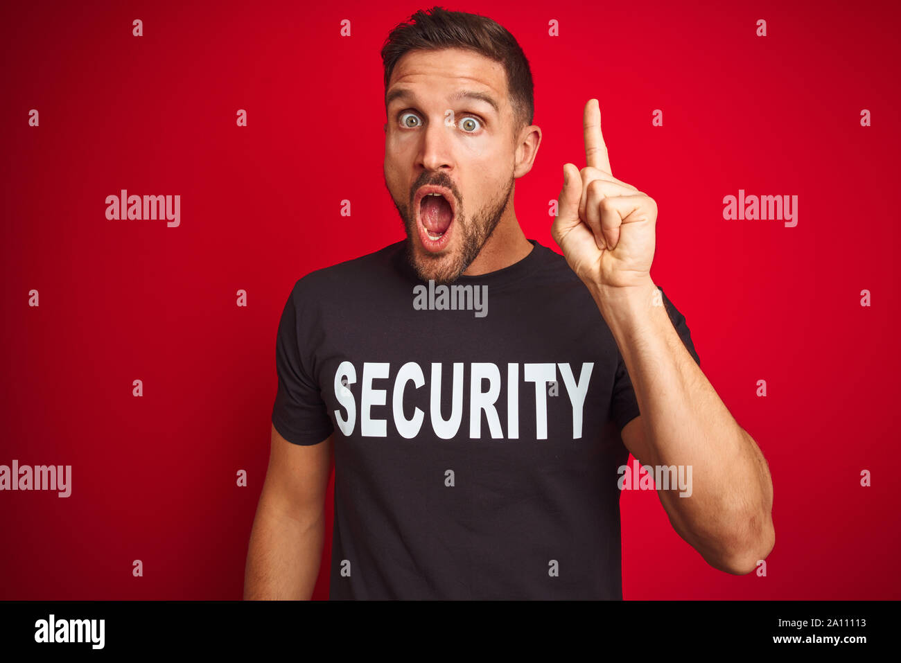 Young safeguard man wearing security uniform over red isolated ...