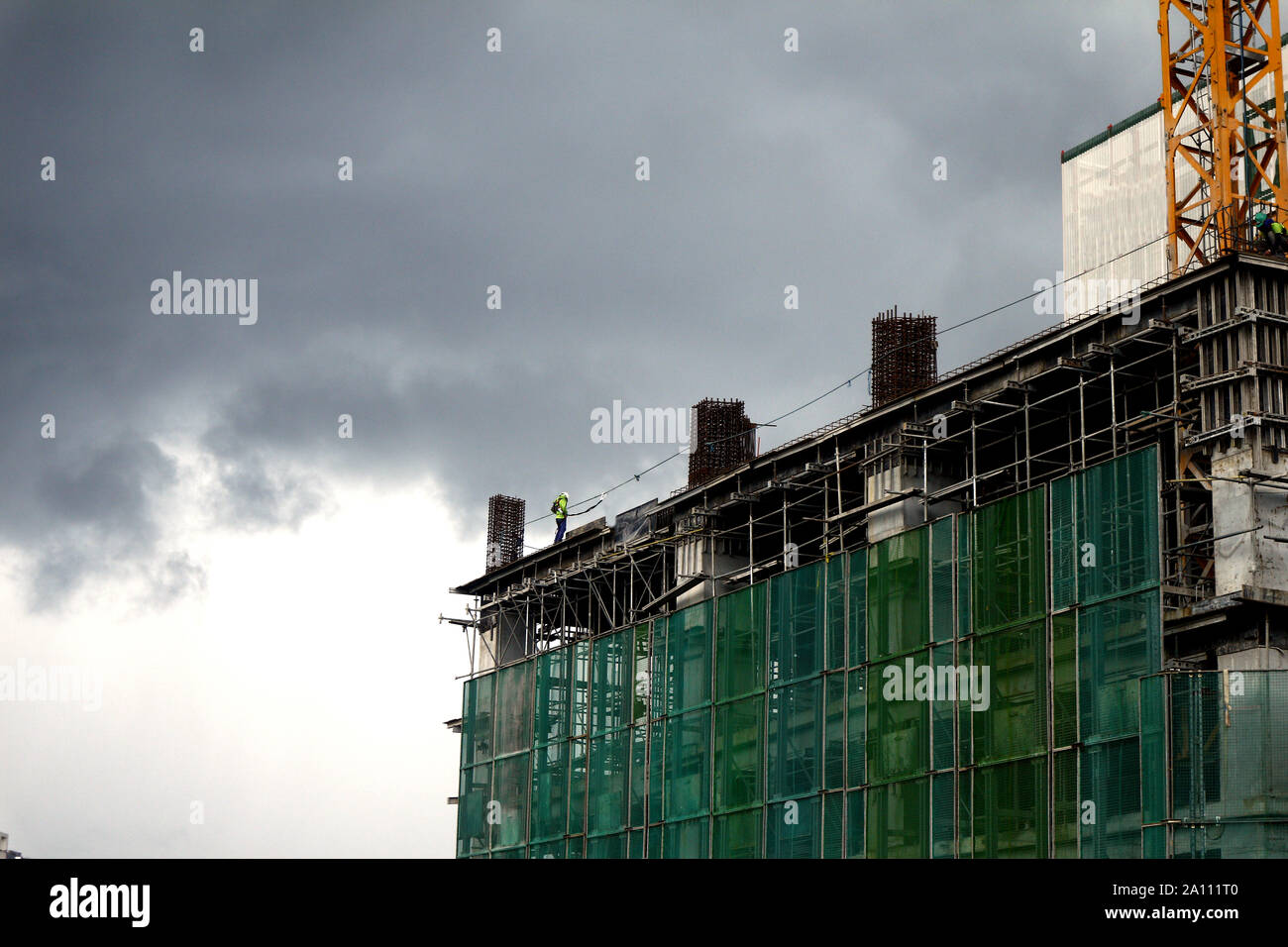 Photo of big and heavy rain clouds over unfinished building ...