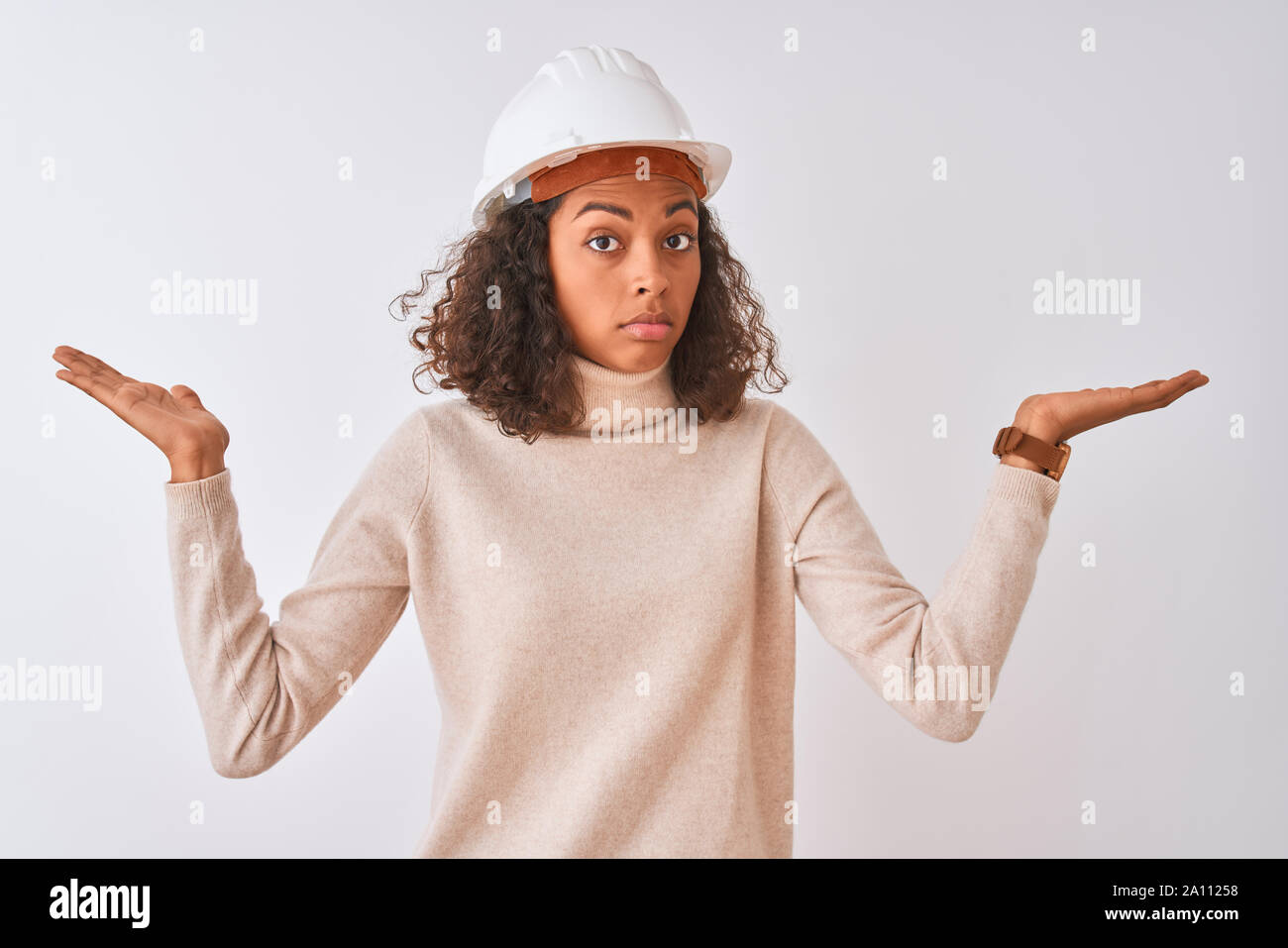 Young brazilian architect woman wearing security helmet over isolated ...