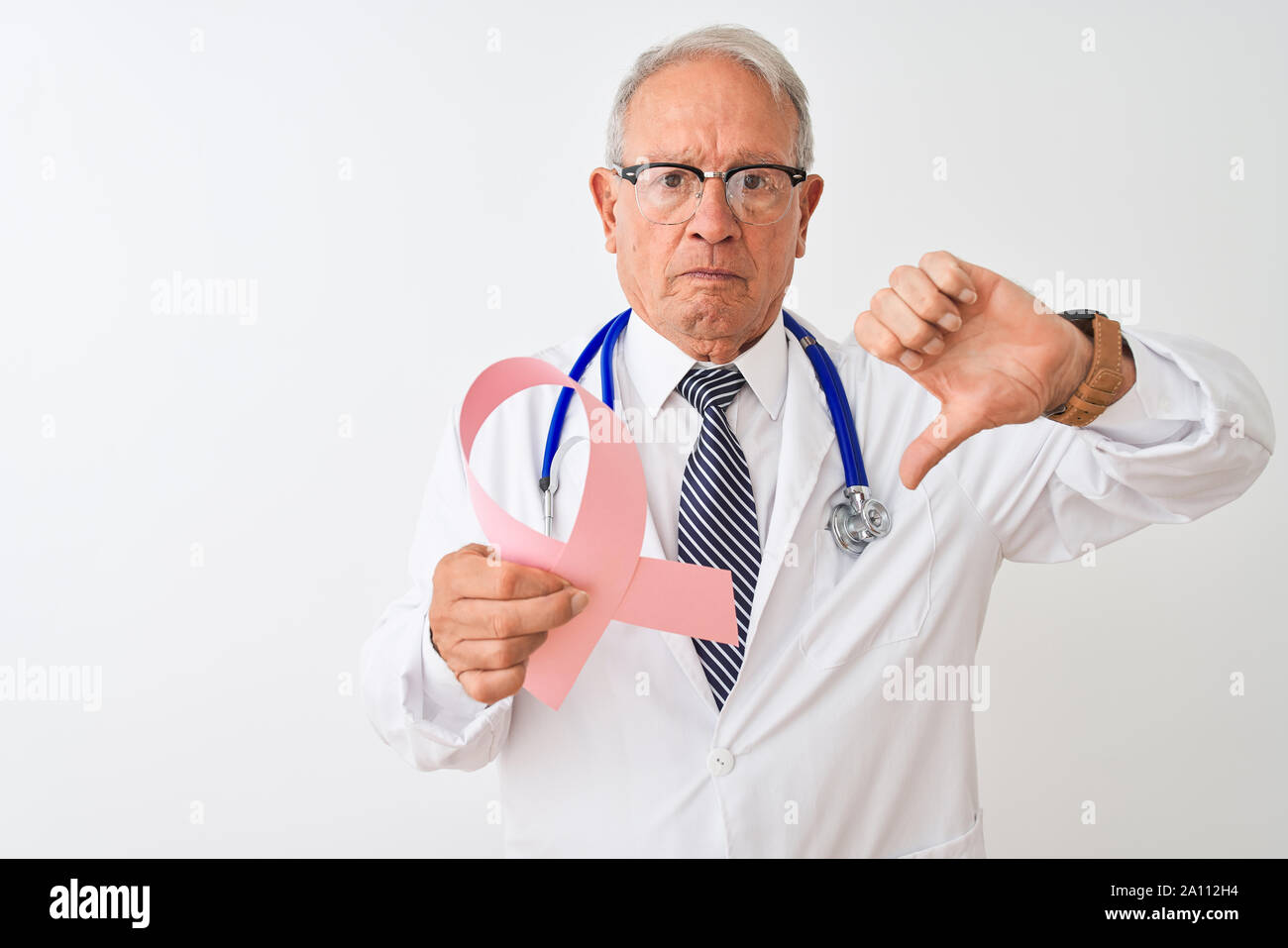 Senior grey-haired doctor man holding cancer ribbon over isolated white ...