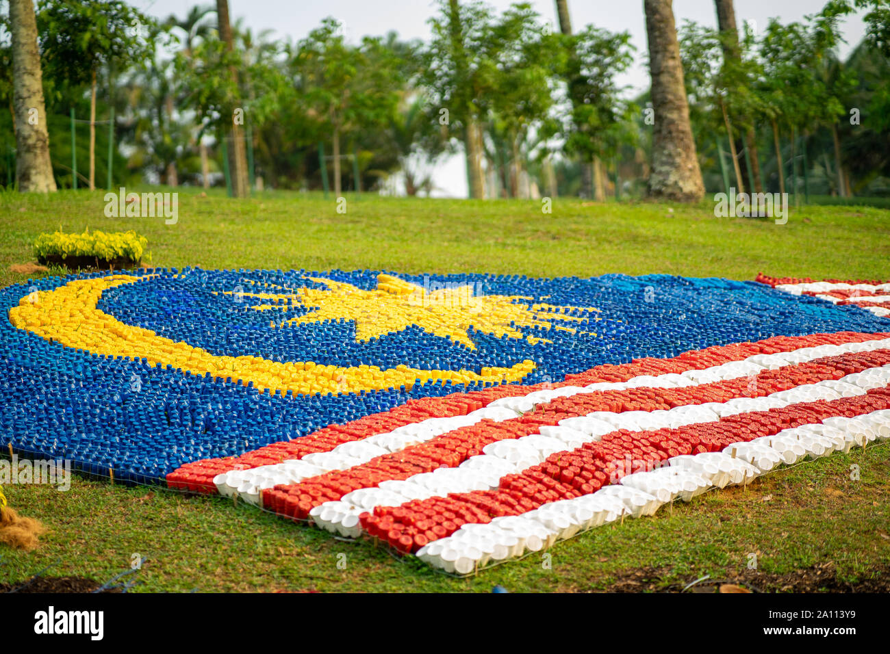 Malaysian flags made from recycled bottles lying on the ground in the ...