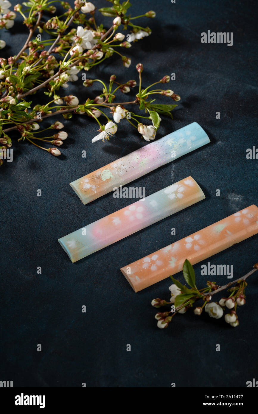 Exclusive chocolate candy and cherry twigs Stock Photo - Alamy