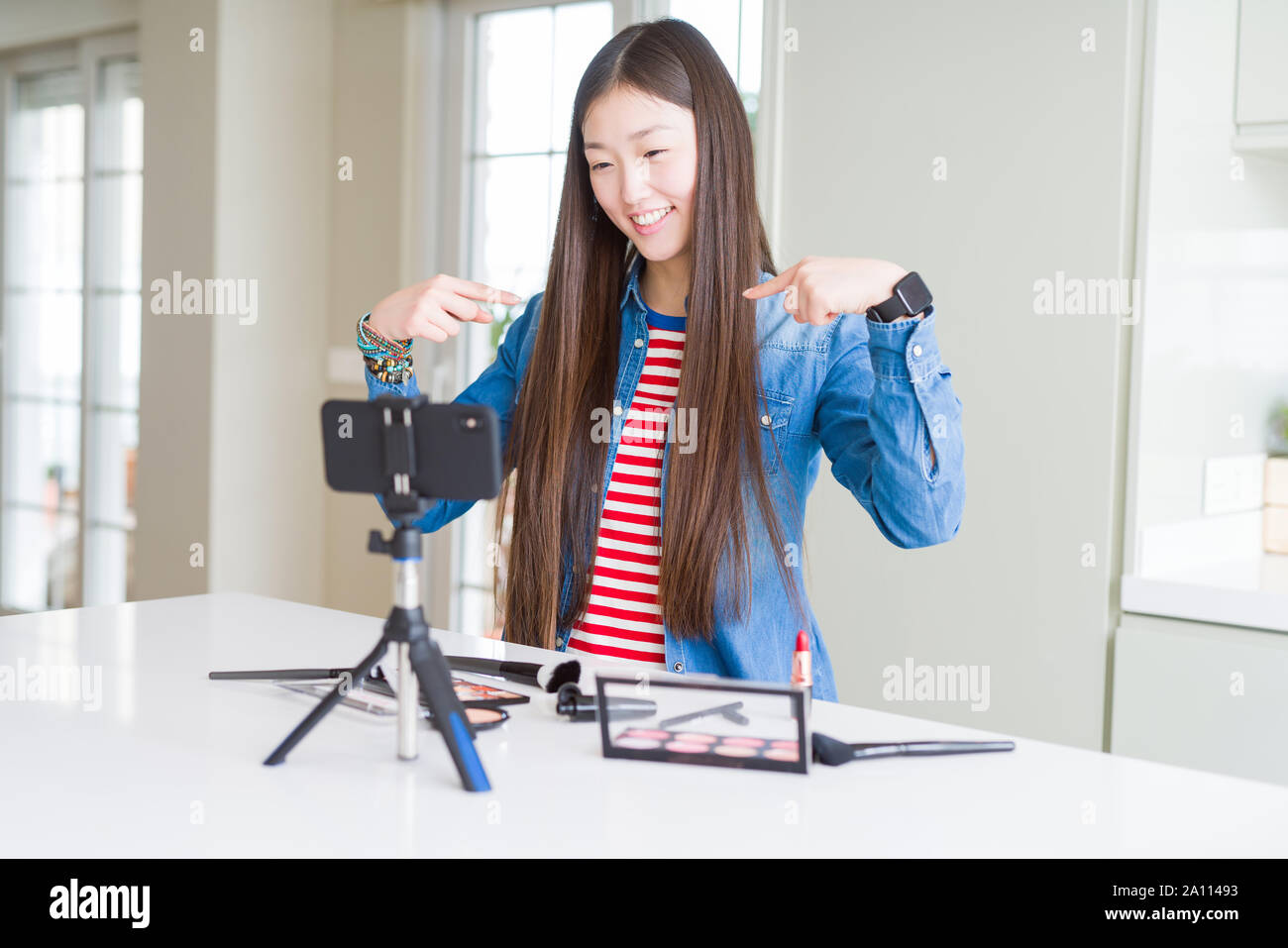 Beautiful Asian influencer woman recording make up tutorial using ...