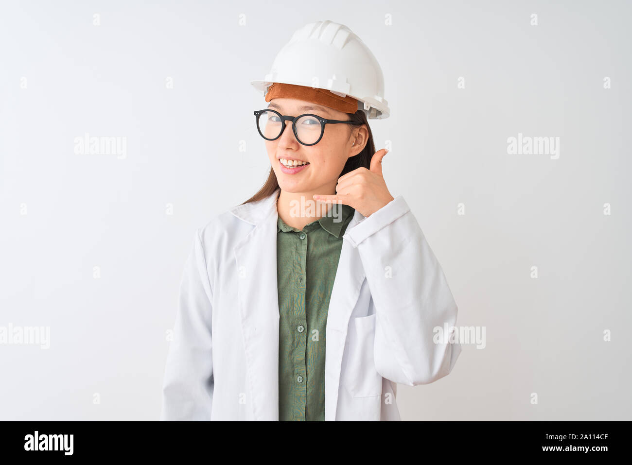 Young chinese engineer woman wearing coat helmet glasses over isolated ...