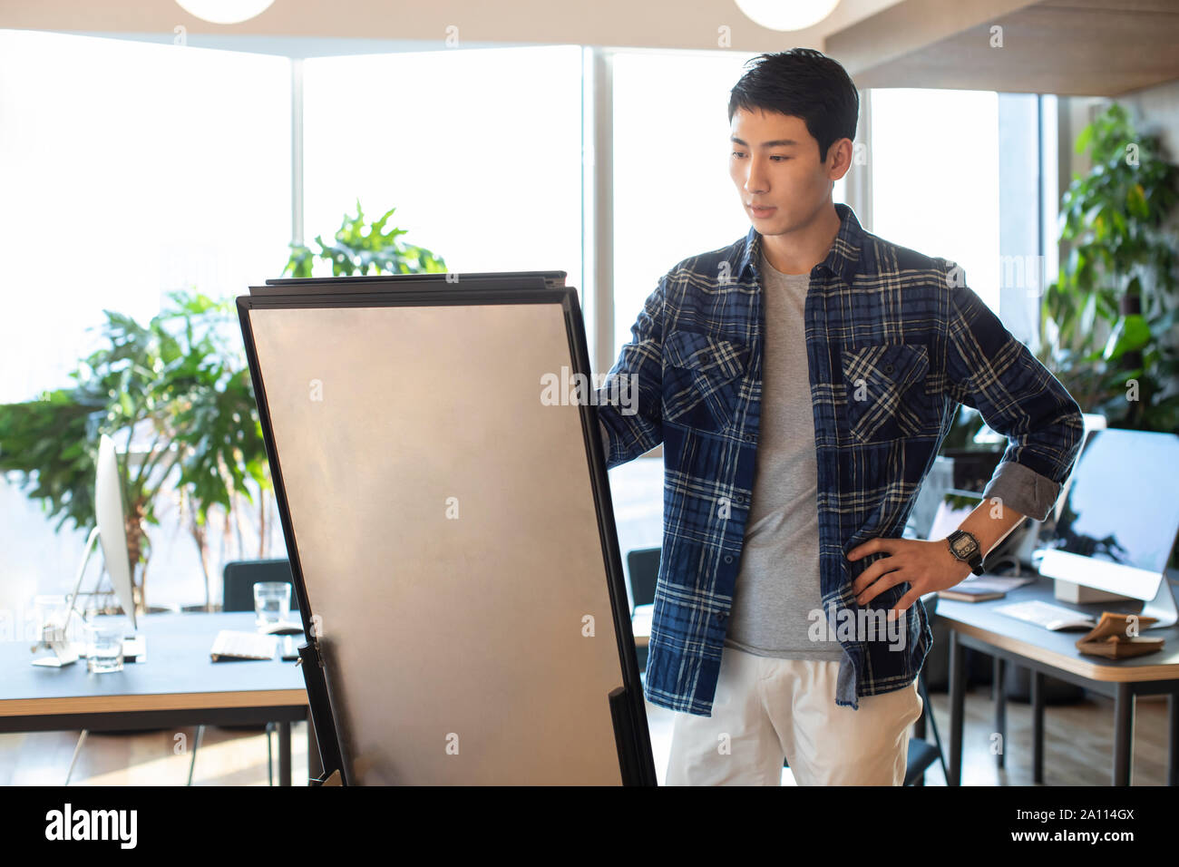 Young college student writing on the whiteboard Stock Photo - Alamy