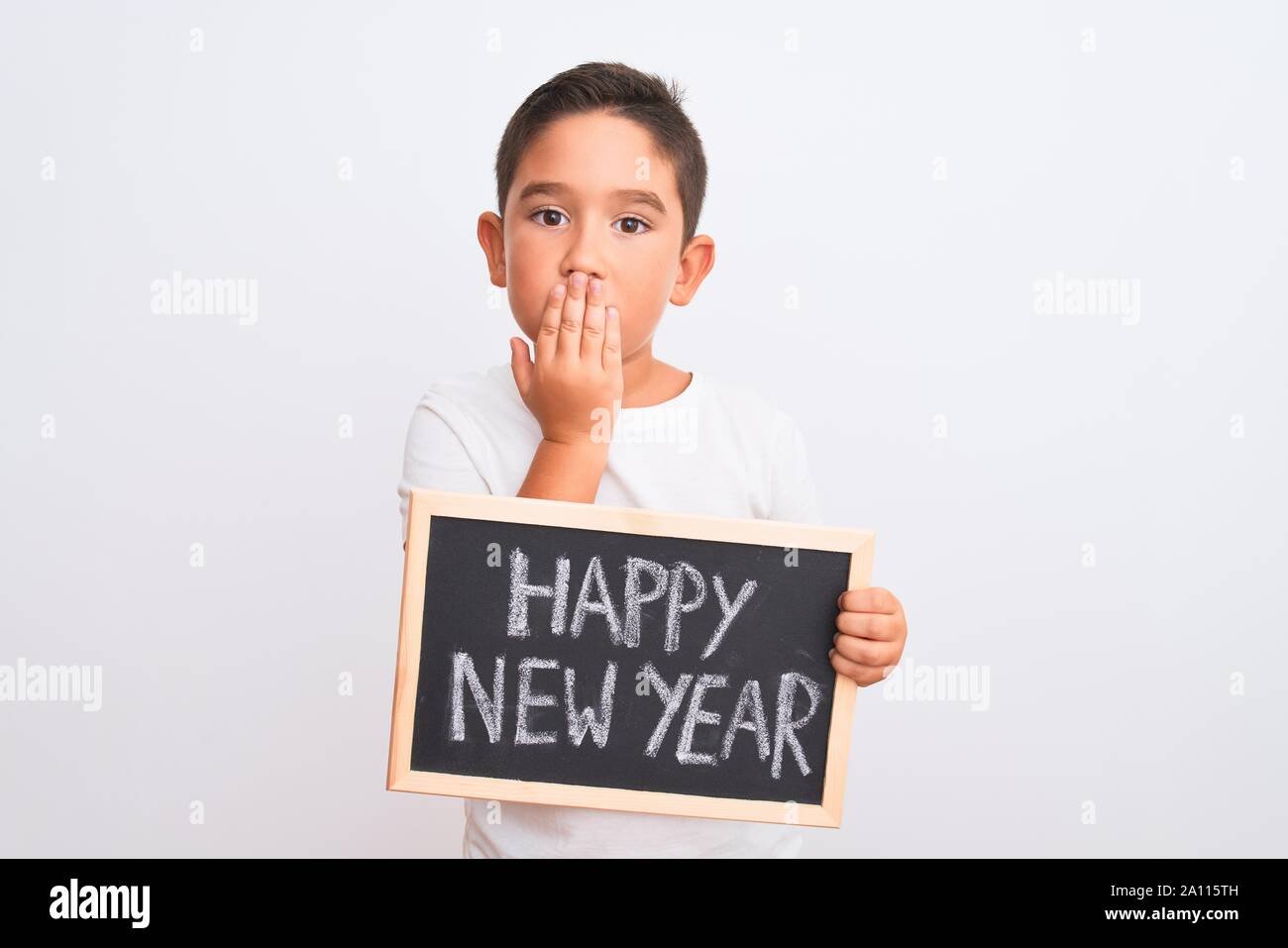Beautiful kid boy holding blackboard standing over isolated white ...