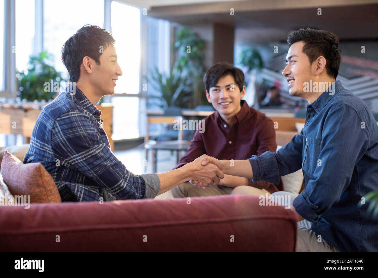 Young college students shaking hands in classroom Stock Photo - Alamy