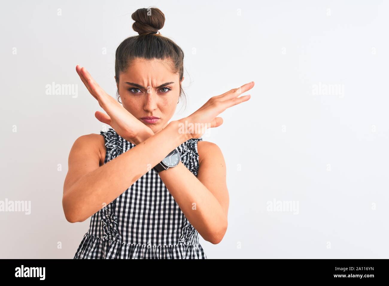 Beautiful woman with bun wearing casual dresss standing over isolated ...