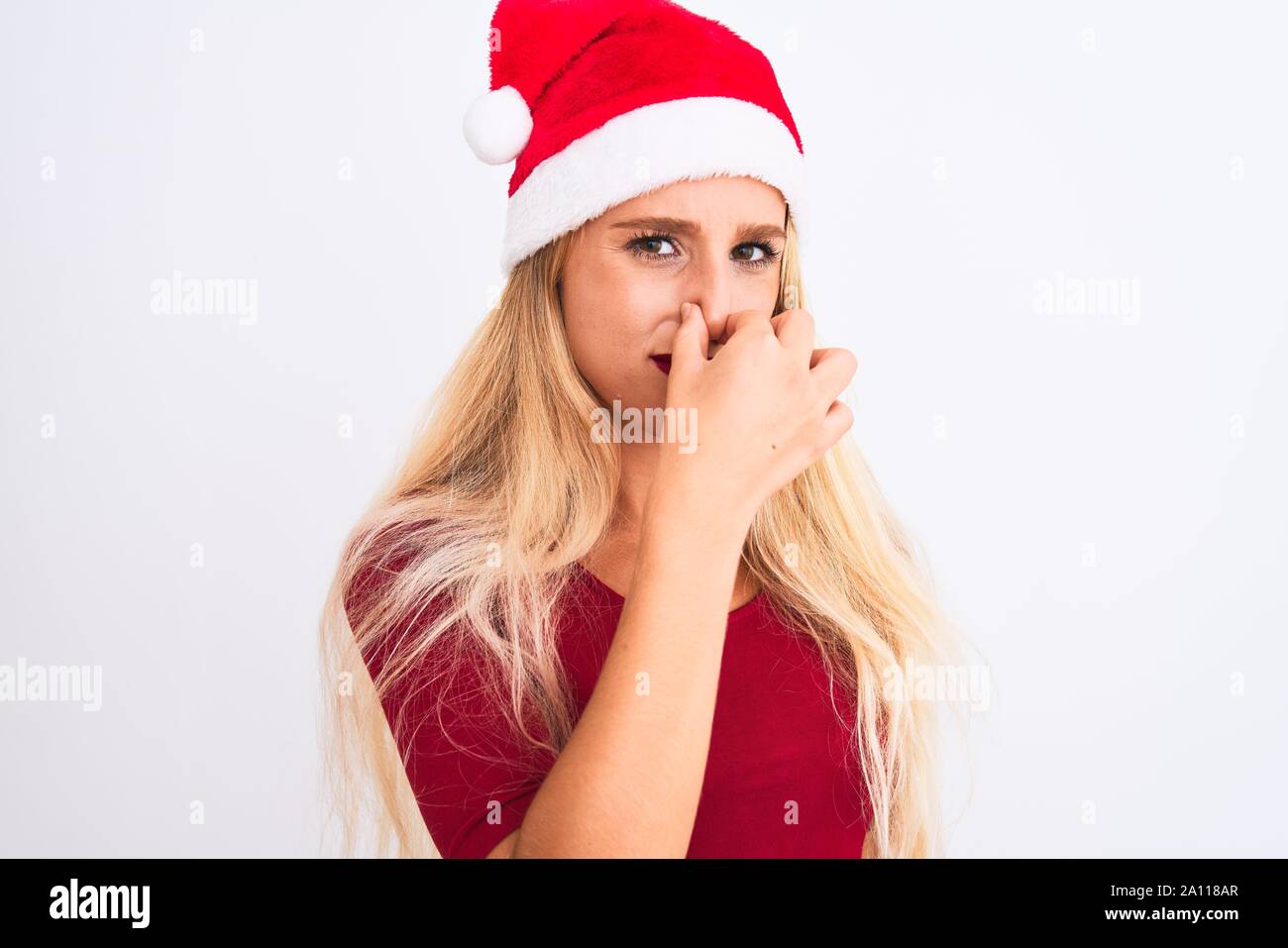 Young beautiful woman wearing Christmas Santa hat over isolated white ...