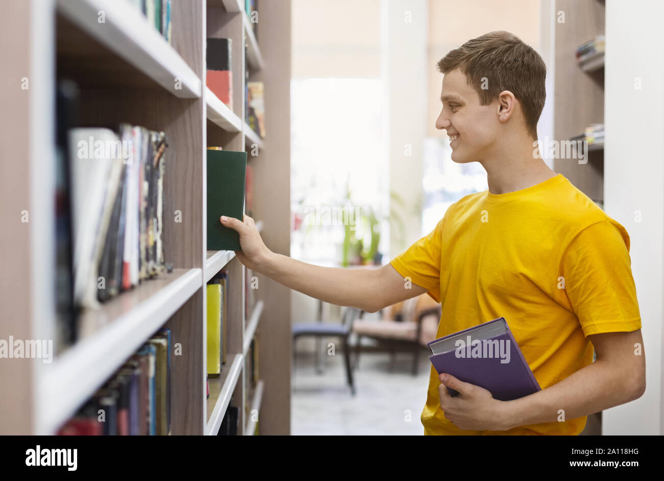 Boy choosing books library hi-res stock photography and images - Alamy