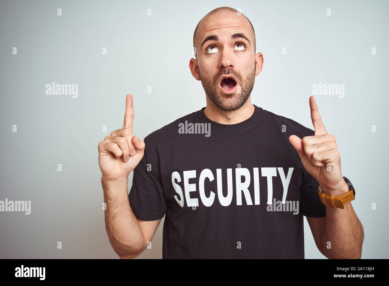 Young safeguard man wearing security uniform over isolated background ...