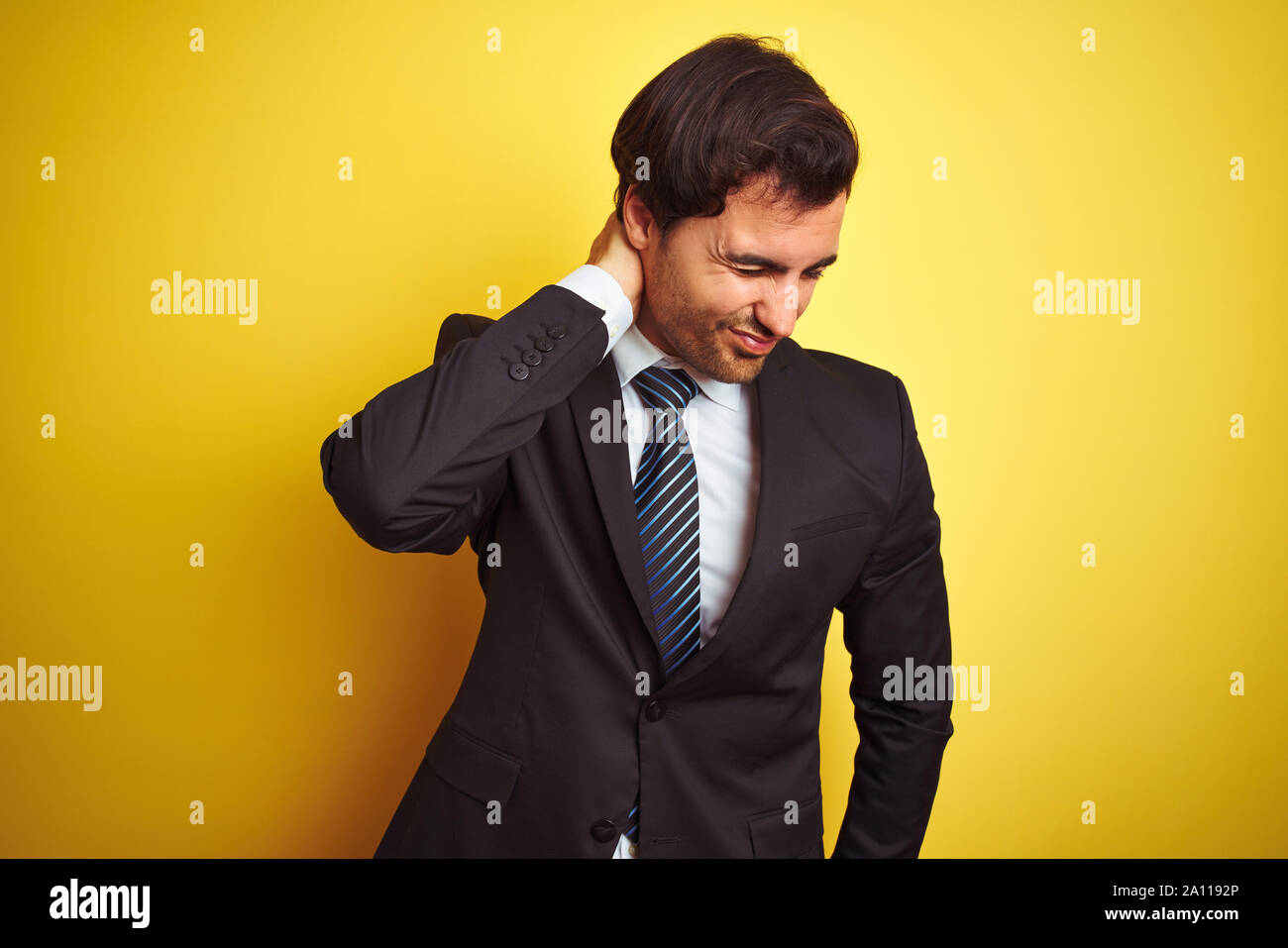 Young handsome businessman wearing suit and tie standing over isolated ...