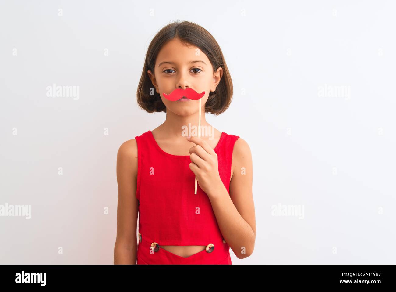 Beautiful child girl holding fanny party mustache standing over ...
