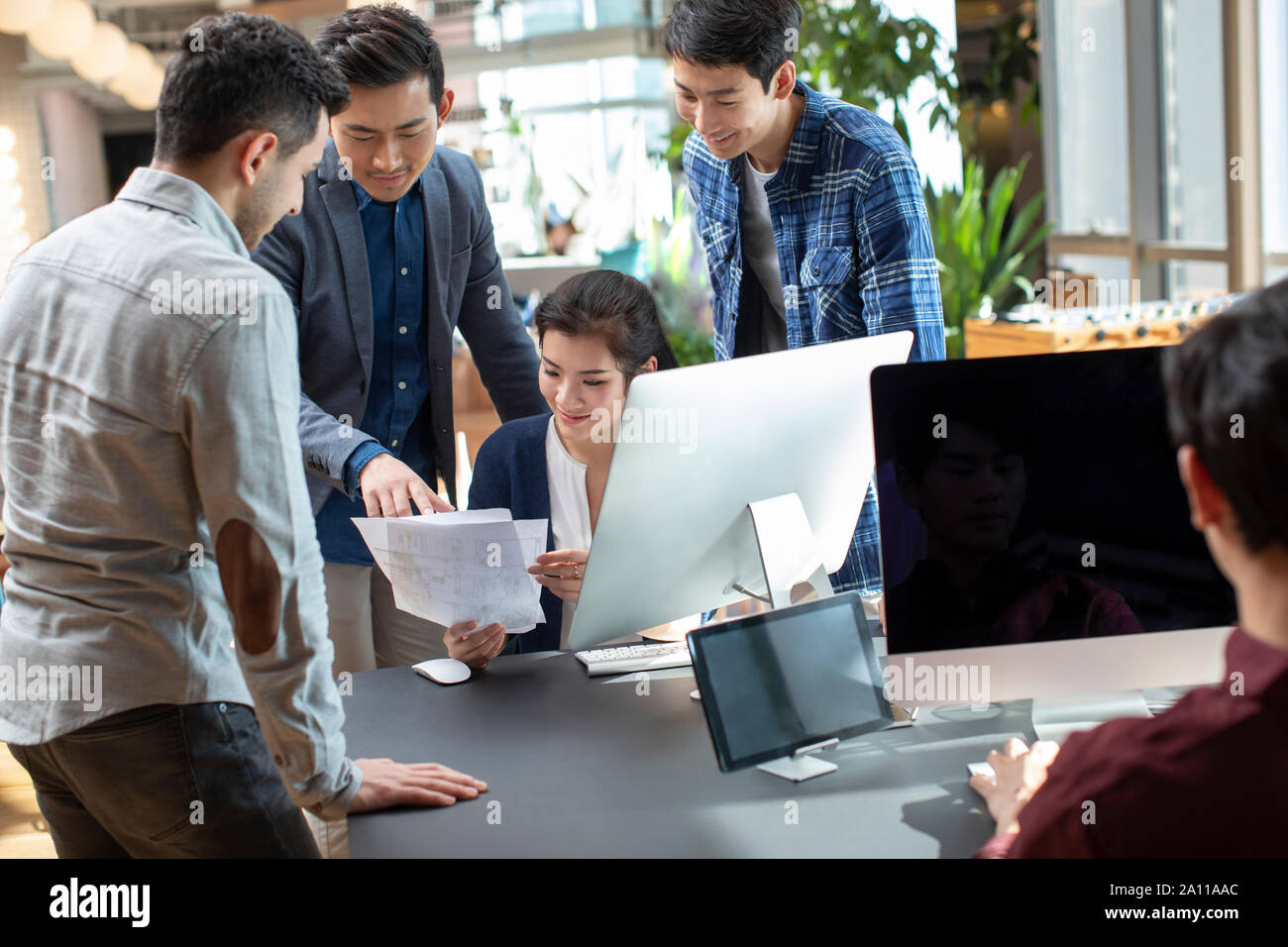 Young abroad students talking with teacher in computer lab Stock Photo ...