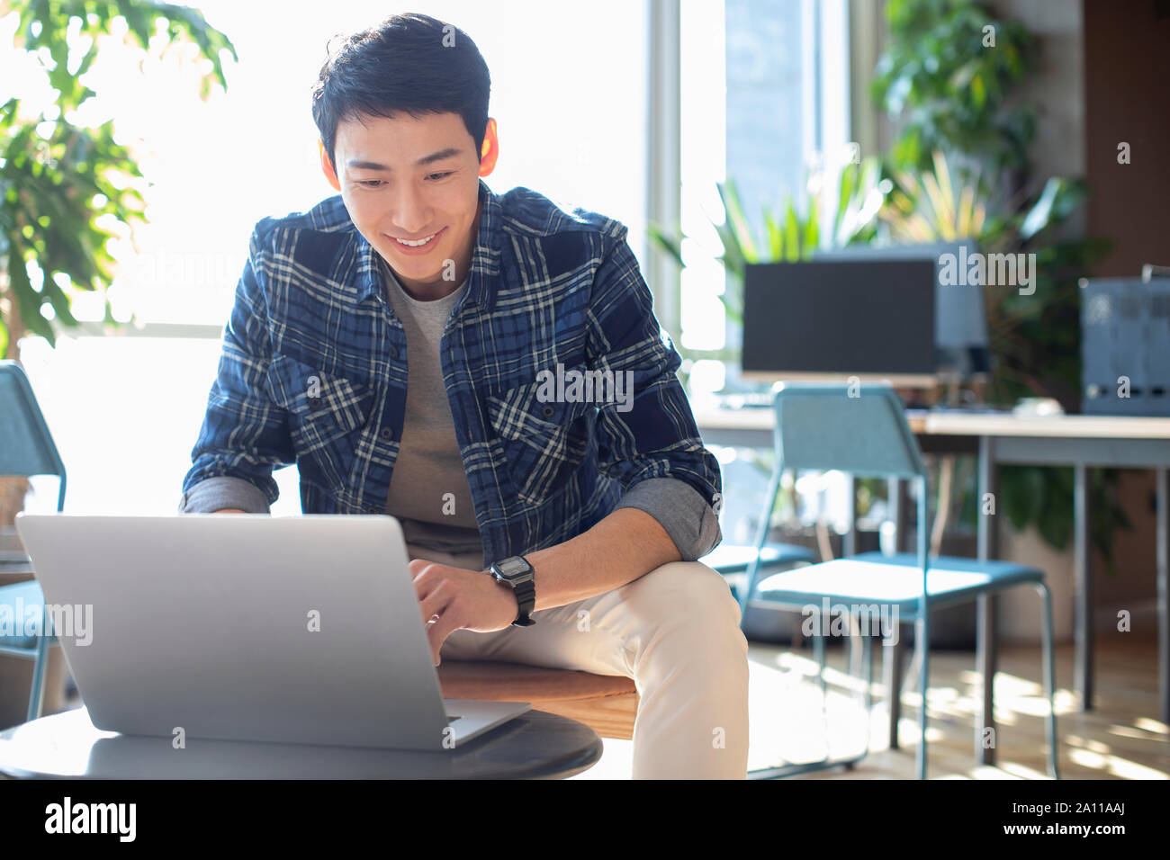 Young college student using laptop in classroom Stock Photo - Alamy