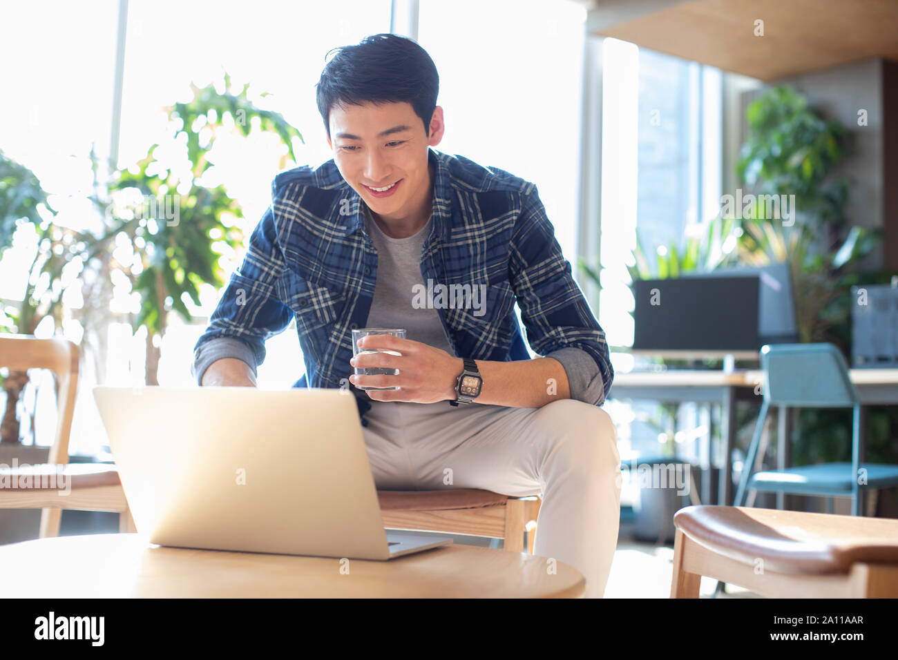 Young college student using laptop in classroom Stock Photo - Alamy